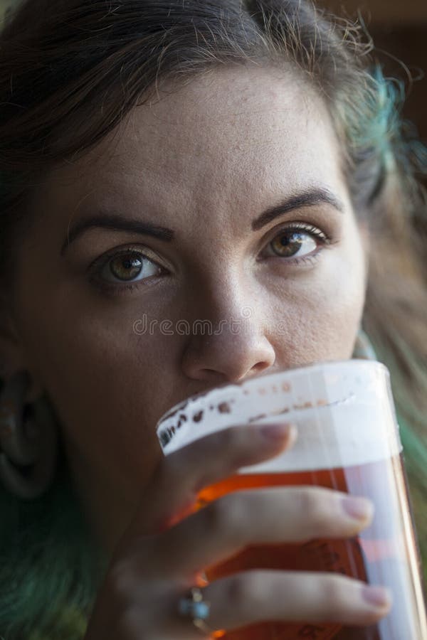 Young Woman Drinking Beer stock image. Image of pint - 28182229