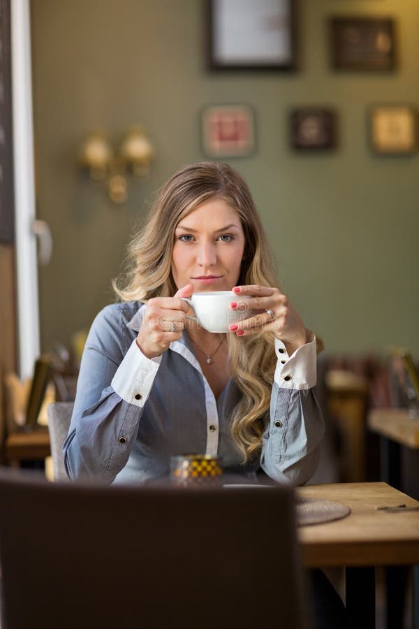 Young Woman Drinking Coffee at Cafe Stock Photo - Image of look ...