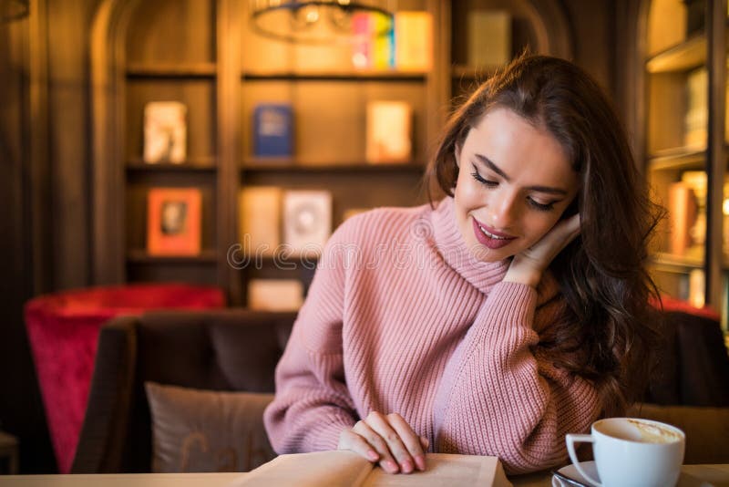 Young Beauty Woman Drinking Coffee and Reading Book in Coffee Shop ... Young Beauty Woman Drinking Coffee and Reading Book in Coffee Shop ...