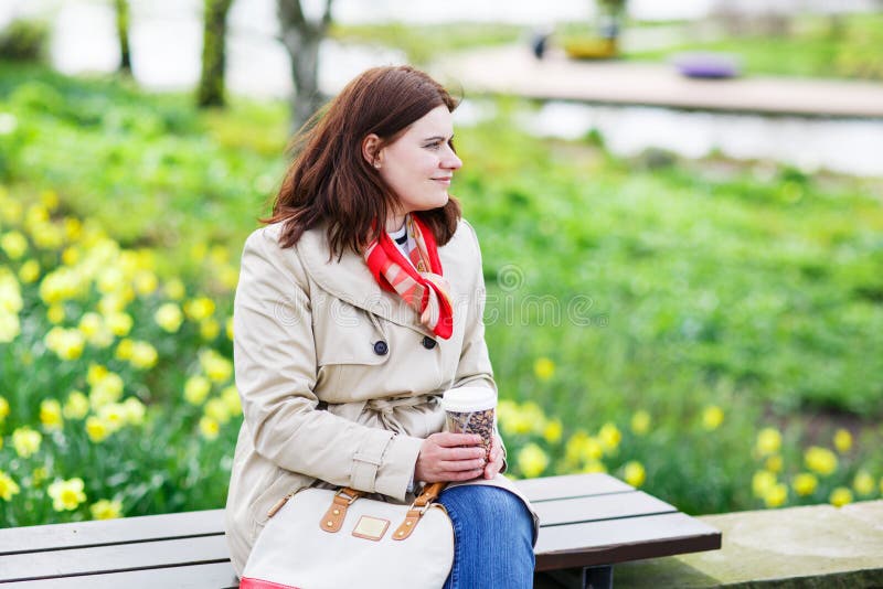 Young Woman Drinking Coffee in Spring Park. Stock Image - Image of ...