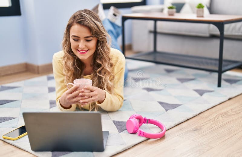 Young Woman Drinking Coffee Using Laptop Lying on Floor at Home Stock Photo - Image of ...