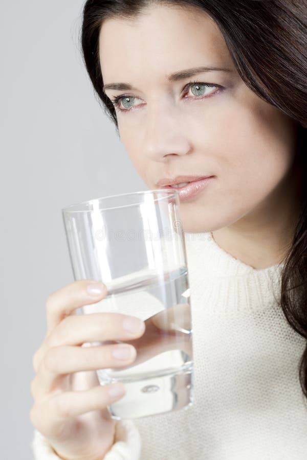 Young woman drinking water stock image. Image of hair - 15887885