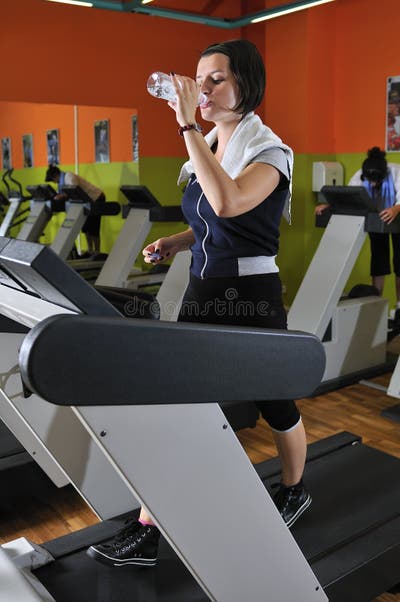 Young Woman Drinking Water while Working Out Stock Photo - Image of ...