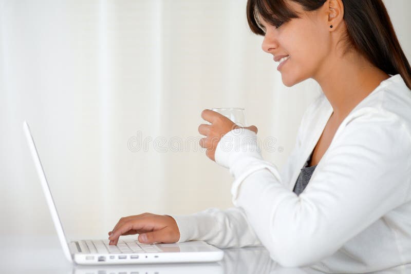 Young Woman Drinking and Working on Laptop Stock Image - Image of ...