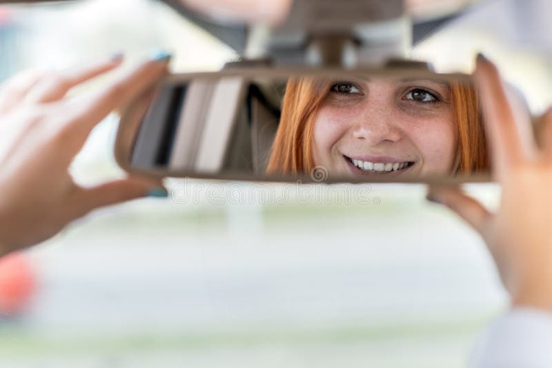 Young Woman Driver Checking Rear View Mirror Looking Backwards while ...