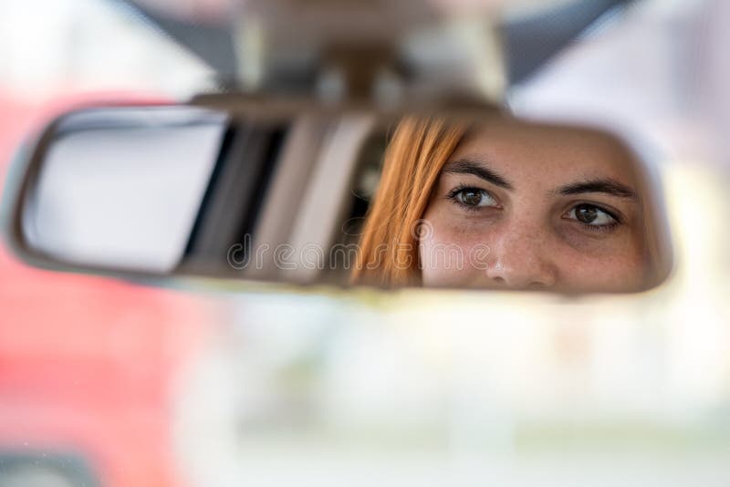 Young Woman Driver Checking Rear View Mirror Looking Backwards while ...