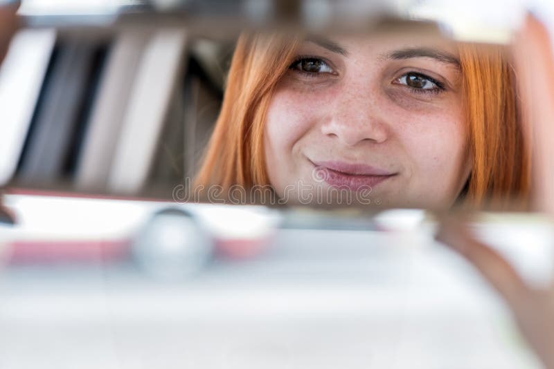 Young Woman Driver Checking Rear View Mirror Looking Backwards while ...