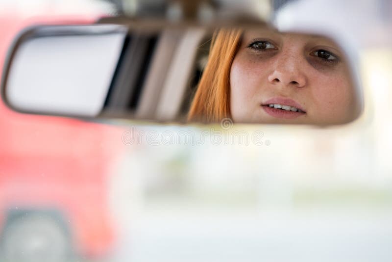 Young Woman Driver Checking Rear View Mirror Looking Backwards while ...