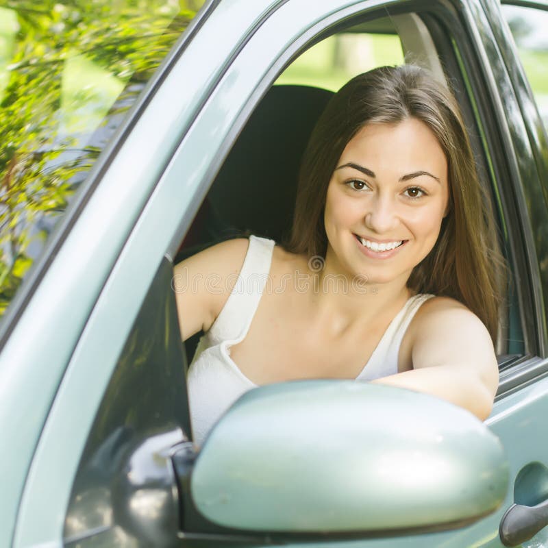 Young woman driving car stock photo. Image of smiling - 42192660