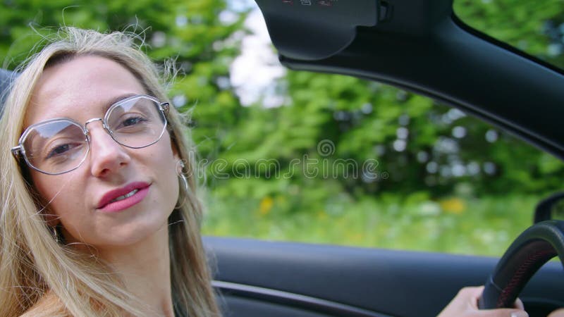 Young Woman Driving Convertible Sport Car In Summer Slow Motion