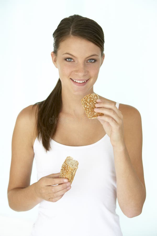 Young Woman Eating a Brown Bread Roll Stock Image - Image of enjoyment ...