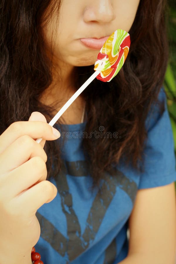 Young Woman Eating Candy at the Park. Stock Image - Image of enjoyment ...