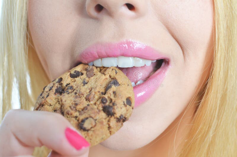 Young woman eating cookie stock photo. Image of food - 37587416