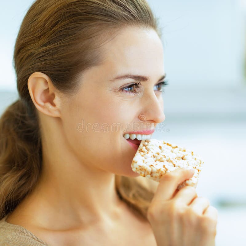 Young Woman Eating Crisp Bread in Kitchen Stock Image - Image of food ...
