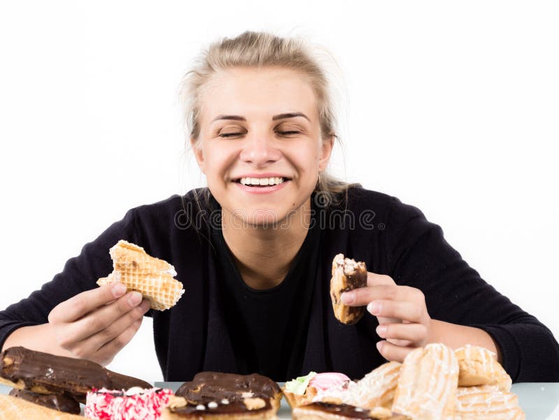 Young Woman Eating Cupcakes with Pleasure after a Diet Stock Image ...