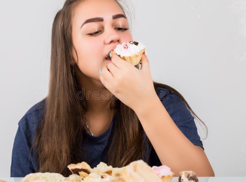 Glutton Woman Eating Cupcakes with Frenzy after Long Diet Stock Photo ...