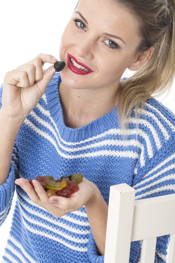Young Woman Eating a Handful of Sweets Stock Photo - Image of sweets ...