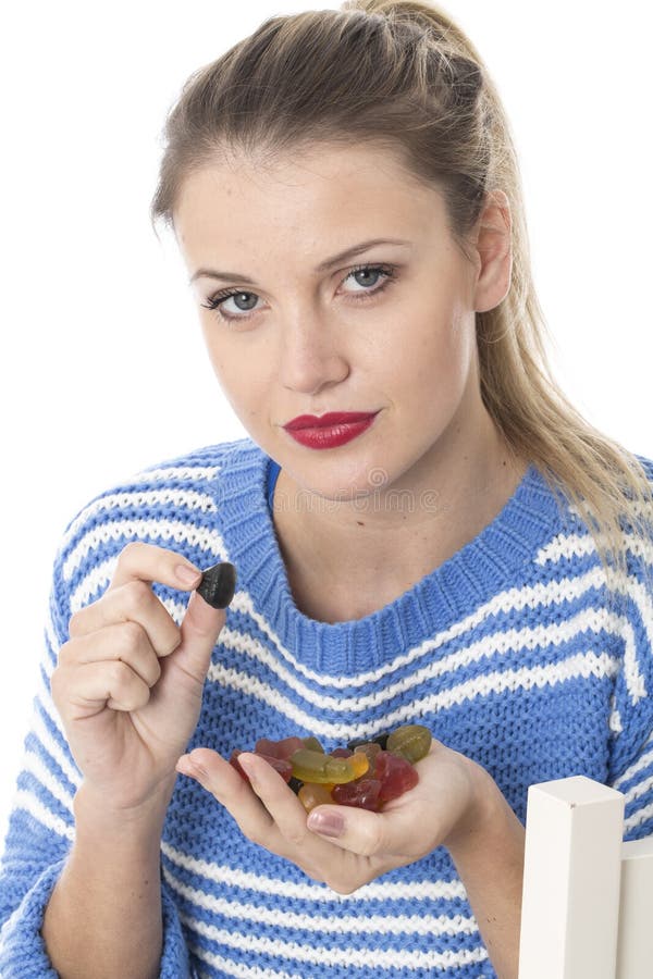 Young Woman Eating a Handful of Sweets Stock Photo - Image of wine ...
