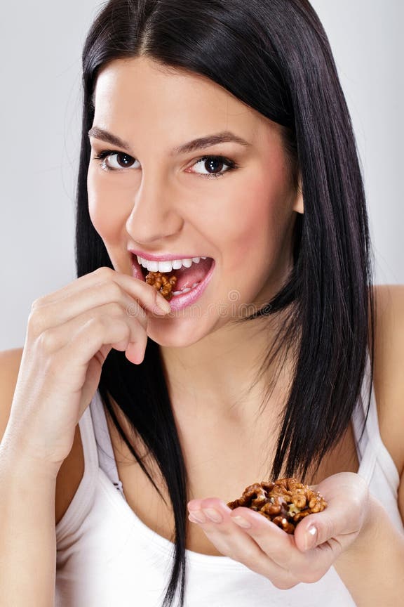 Young woman eating nut stock photo. Image of mouth, face - 26438480