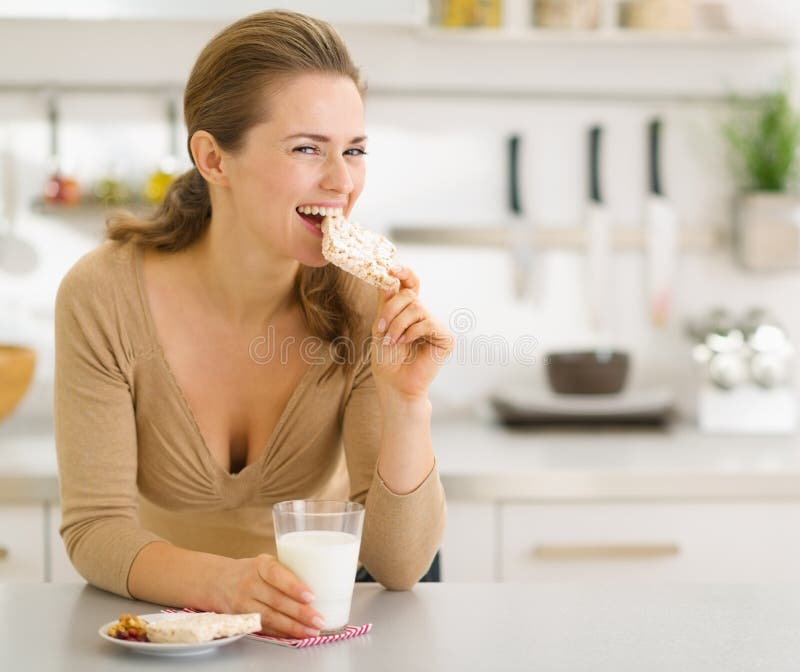 Young Woman Eating Snacks in Modern Kitchen Stock Photo - Image of ...