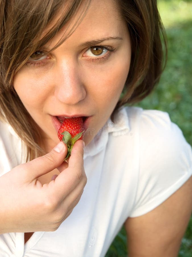 Young Woman Eating Strawberry Stock Image - Image of beautiful, green ...