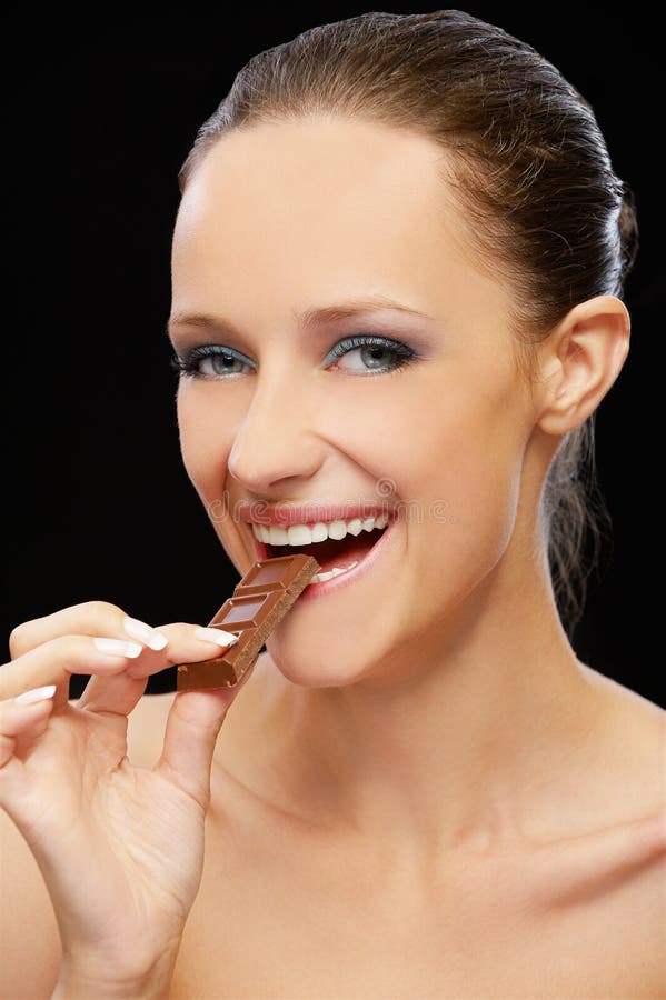 Woman eating chocolate stock photo. Image of pretty, food - 55112586