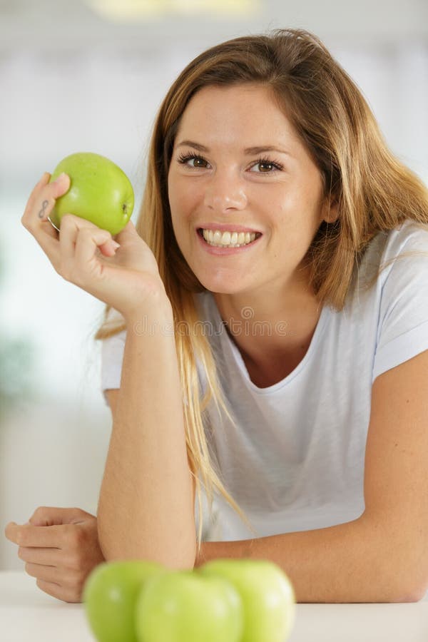 Young woman eats apple stock image. Image of beauty - 164145827