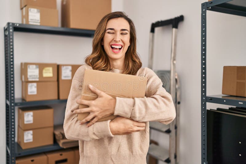 Young Woman Ecommerce Business Worker Hugging Package at Office Stock ...