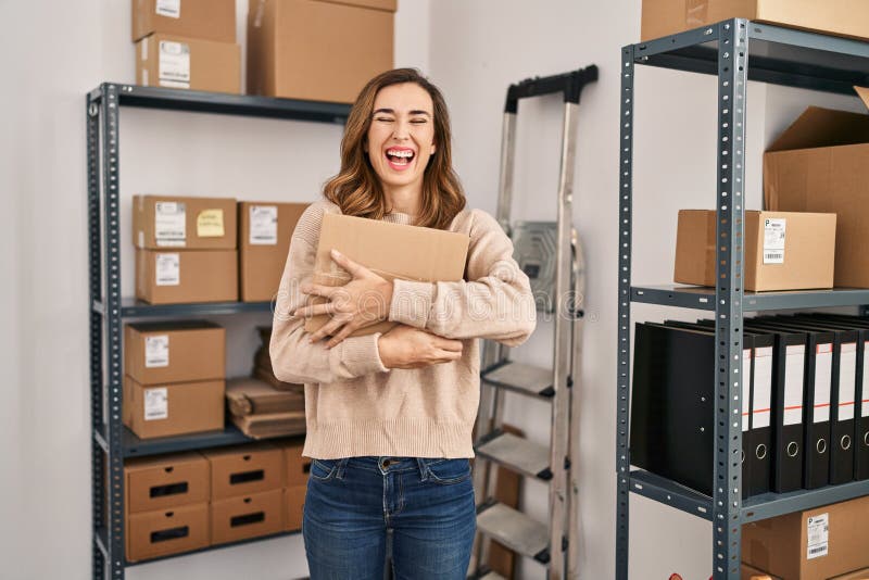 Young Woman Ecommerce Business Worker Hugging Package at Office Stock ...