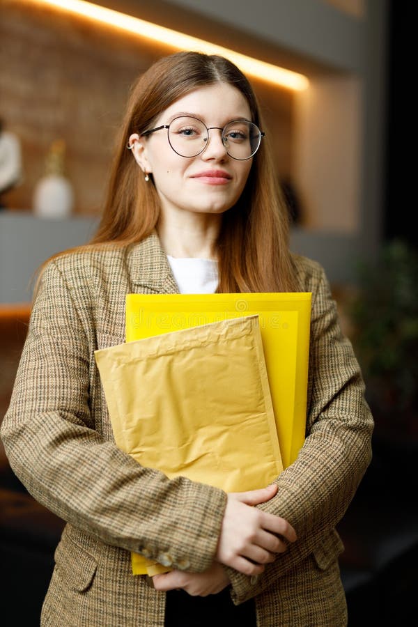 Young Woman Employee Trainee in a Jacket with Folders in Her Hands ...