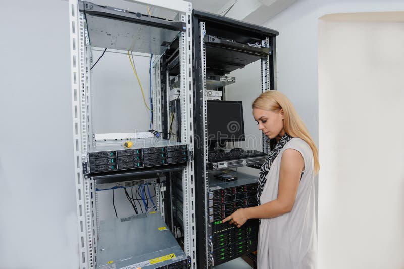 Young Woman Engineer it between the Server Racks in the Data Ce Stock ...