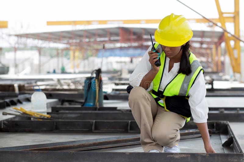 Young Woman Engineer Using Radio Command with Worker in Construction ...