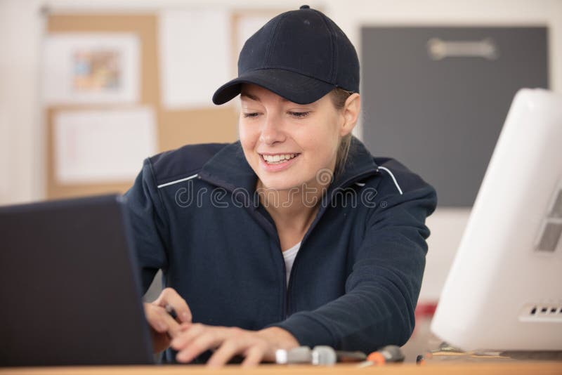 Young Woman Engineer Wearing Cap Fixing Computers Stock Photo - Image ...