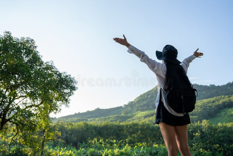 A Young Woman Enjoying Freedom with Open Hands on Mountain Stock Photo ...