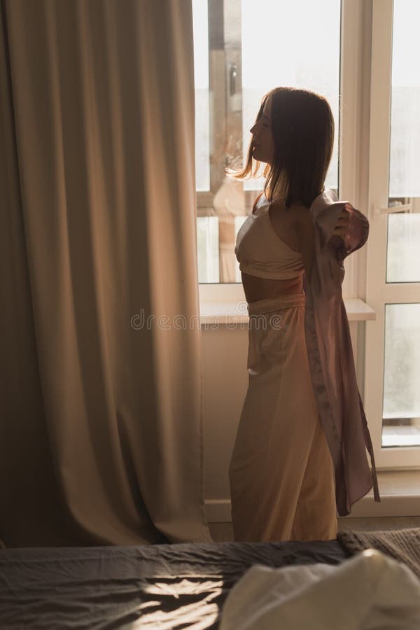 Young Woman Enjoying Sunny Morning On Bedroom Wake Up And Wellness