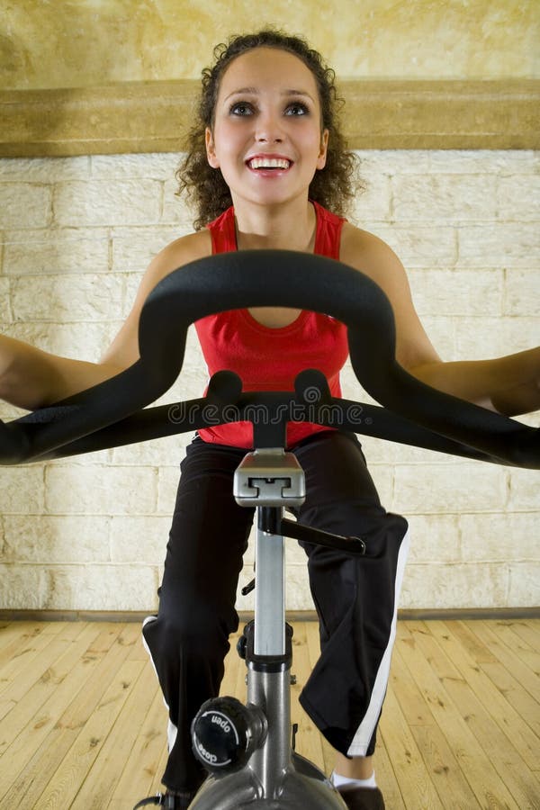 Young Woman on Exercise Bike Stock Image - Image of lifestyle, sport ...