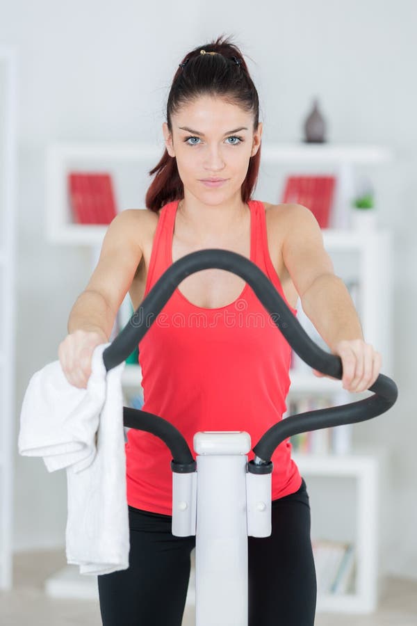 Young Woman on Exercise Machine Stock Photo - Image of routine, young ...