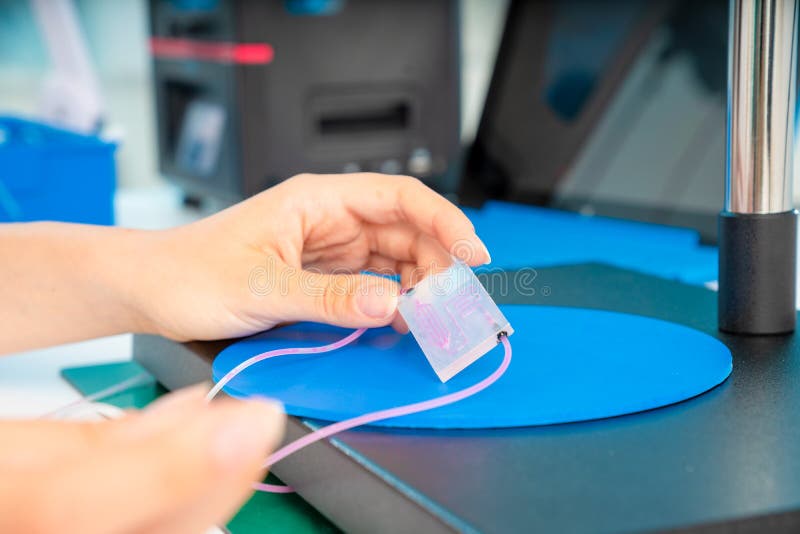 A Young Woman is Experimenting with Lan on Chip Devices. Microfluidics ...