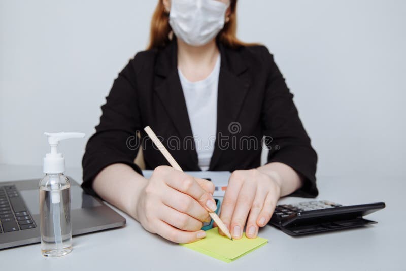 Young Woman in Face Mask Working on Office Desk. Working with Laptop ...