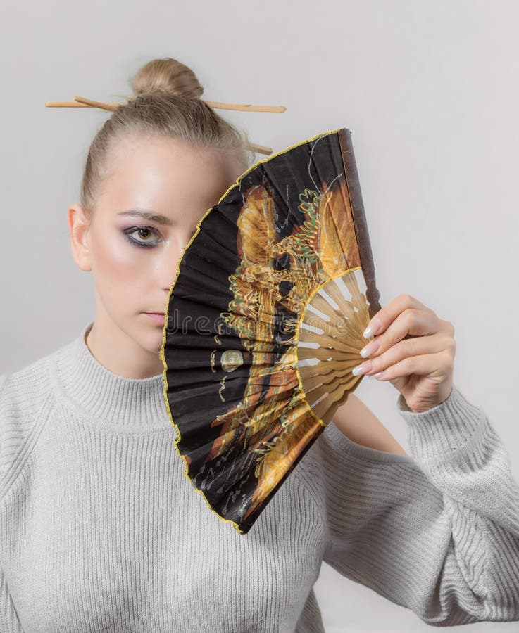Young woman with a fan stock photo. Image of beauty - 133002024