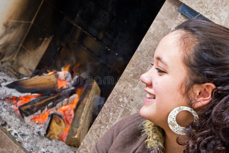 Young woman by the fire stock photo. Image of smiling - 14931150