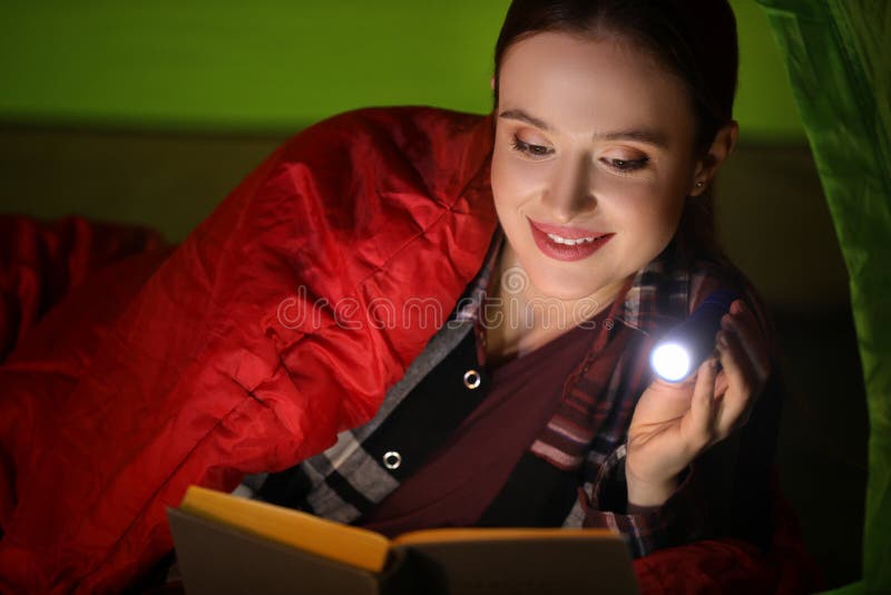 Young Woman with Flashlight Reading Book Stock Image - Image of person ...