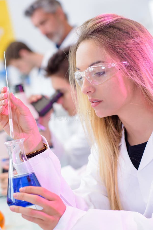Young Woman with Flask and Rod Stock Photo - Image of stir, learning ...