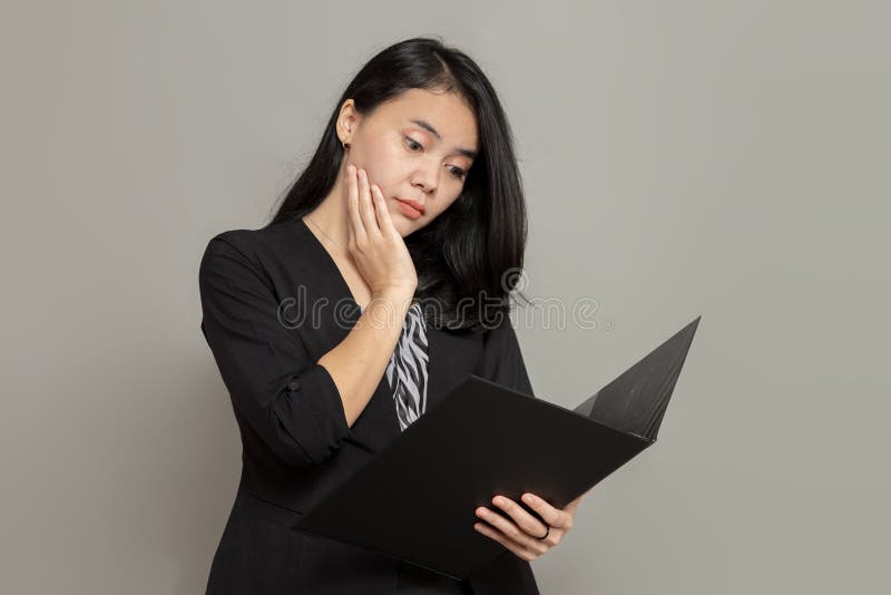 Young Woman with a Flat Facial Expression while Looking at and Holding ...