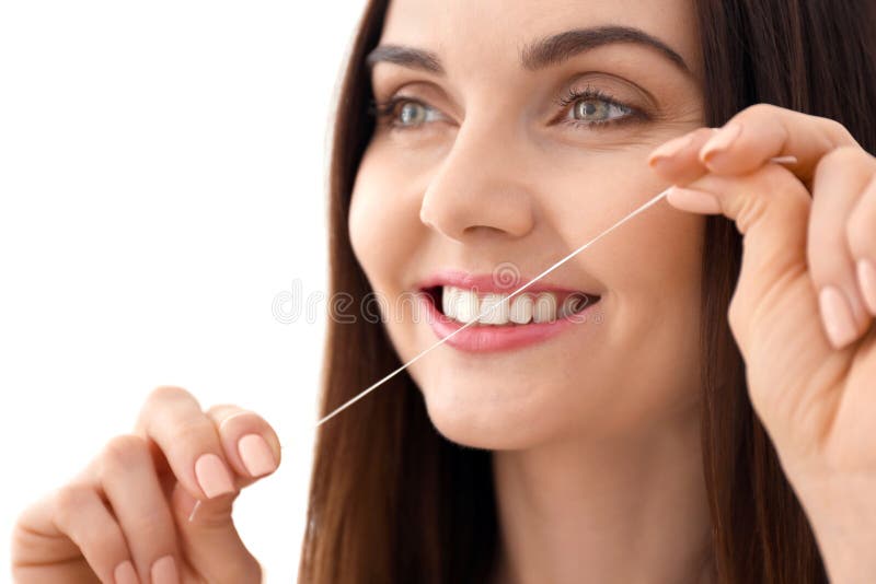 Young Woman Flossing Her Teeth on Light Background Stock Image - Image ...