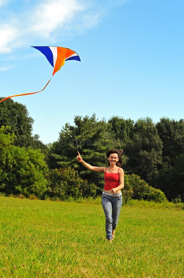 Young woman flying a kite stock image. Image of energy - 16306369
