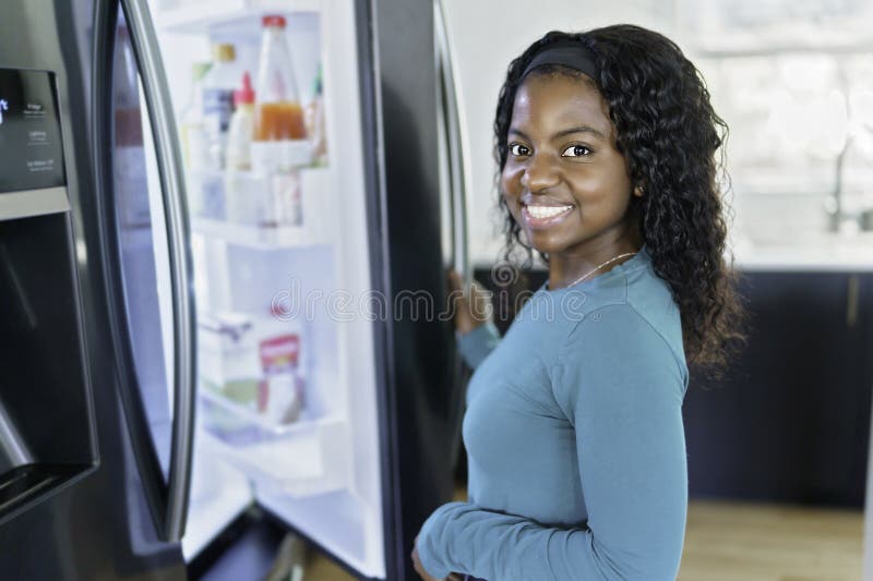Young Woman on Front of Fridge at Kitchen Stock Photo - Image of ...