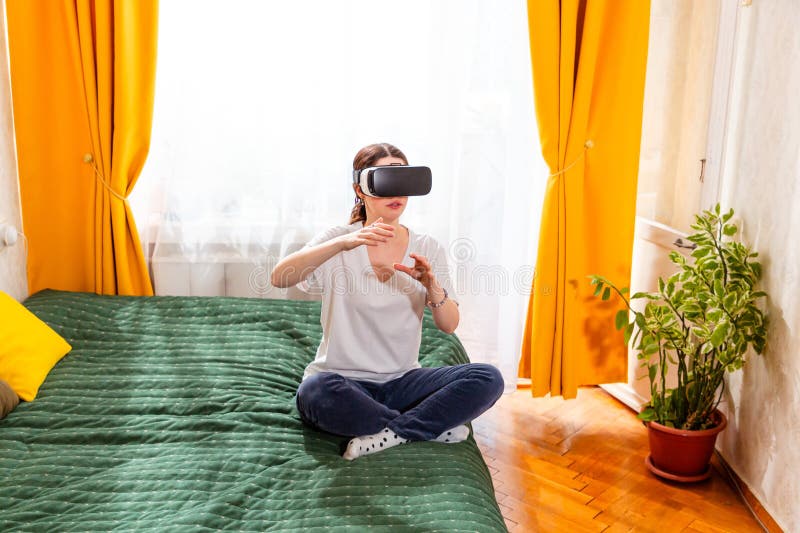 Young Woman Fully Immersed in a Virtual Reality Experience while ...