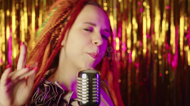 Young Woman with Ginger Dreadlocks Singing into Microphone. Portrait of ...