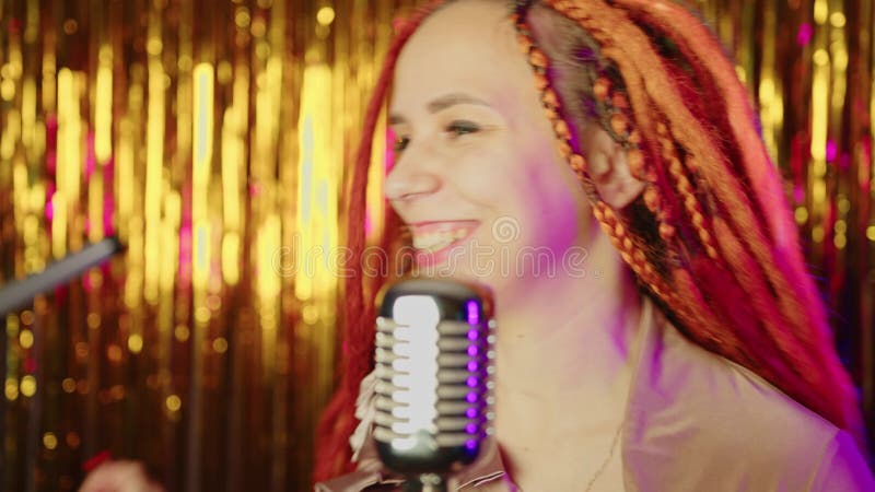 Young Woman with Ginger Dreadlocks Singing into Microphone. Portrait of ...